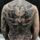 Top 26 Elegant and Badass Skull Back Tattoo Designs for Men